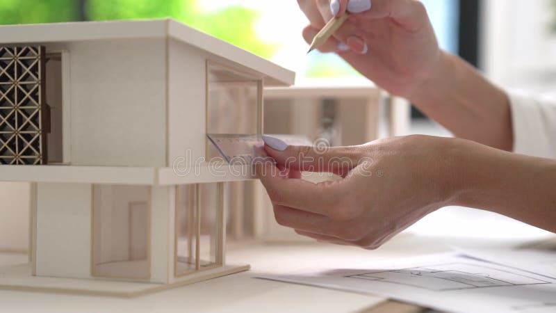 Closeup of Engineer Hand Measure House Model and Write on Blueprint ...
