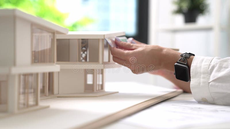 Closeup of Engineer Hand Measure House Model and Write on Blueprint ...