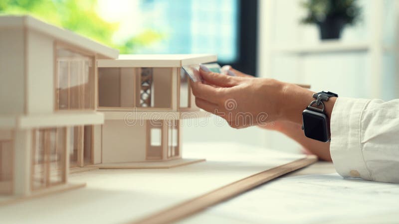 Closeup of Engineer Hand Measure House Model and Write on Blueprint ...