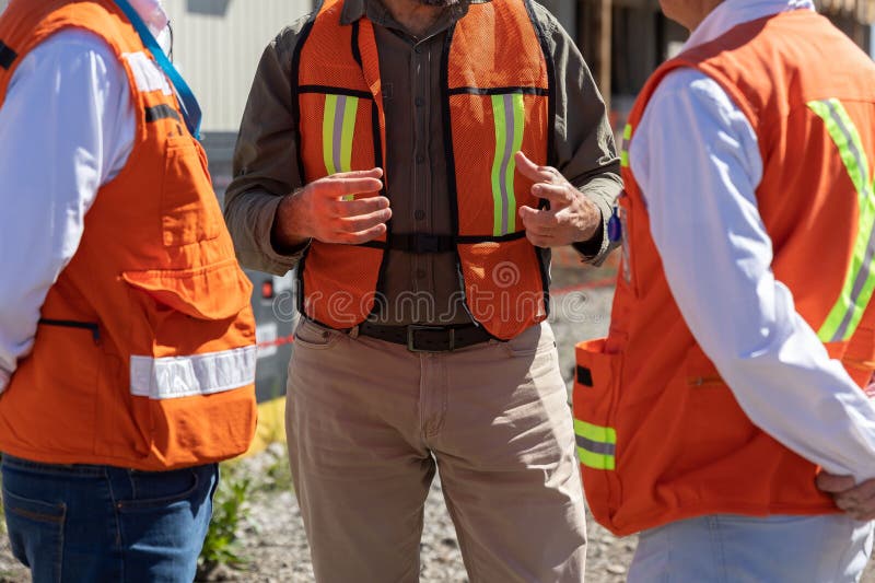 Closeup of Engineers in Orange Vests at a Meeting before Working in the ...
