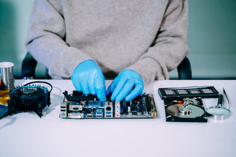 Closeup of Expert Soldering a Green PCB Board Using Precision Tools. Ideal for Electronics ...