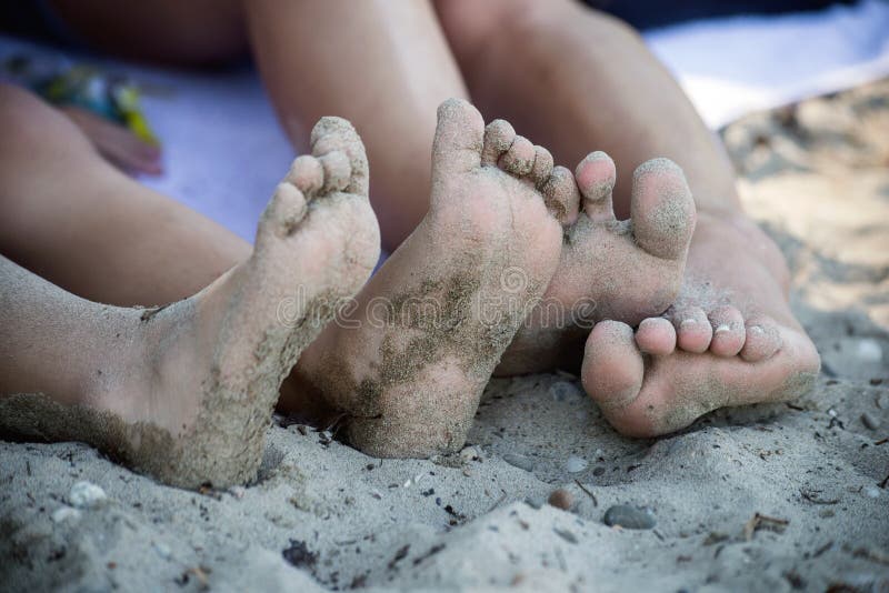 Feet Covered by Sand on the Beach Stock Photo - Image of ocean, holiday ...