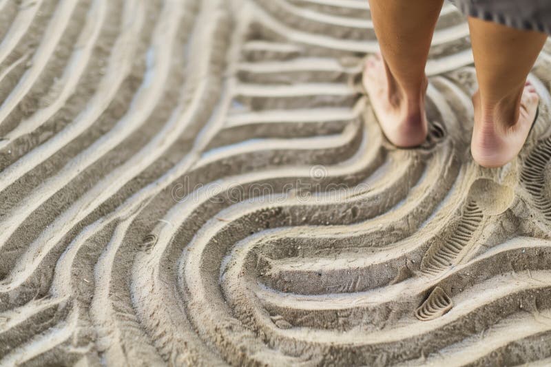 Closeup on Feet Walking Carefully beside Raked Sand Patterns Stock ...