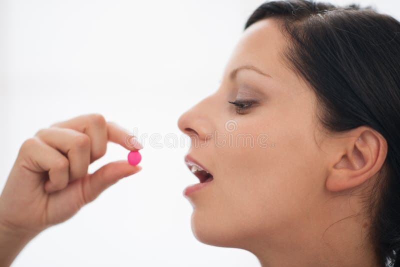 Closeup on Female Eating Tablet Stock Photo - Image of brunette, white ...