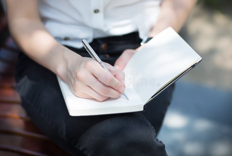 Closeup of a Female Hand Writing on an Blank Notebook with a Pen. Stock ...