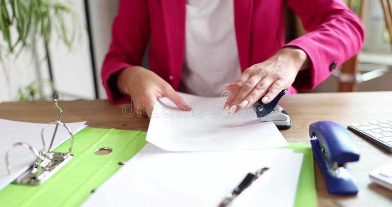 Closeup of Female Hands Punching Holes Using Documents in Office Stock ...