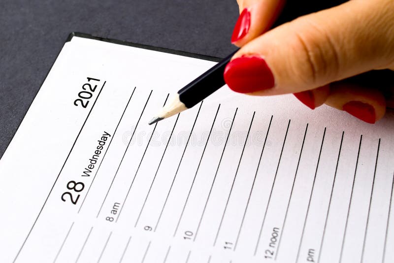 Closeup of a Female with a Pencil Making Notes on Wednesday Page Stock ...