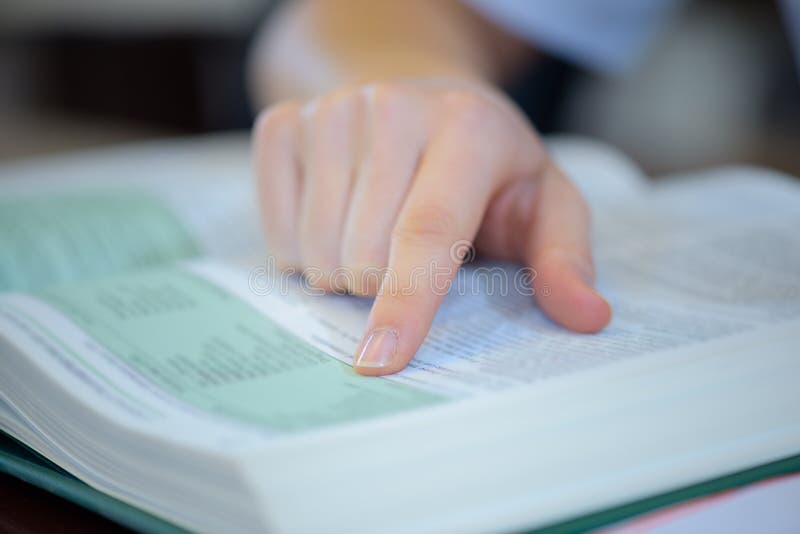 Index Finger of the Left Hand Pointing To the Text Line of a Book Stock ...
