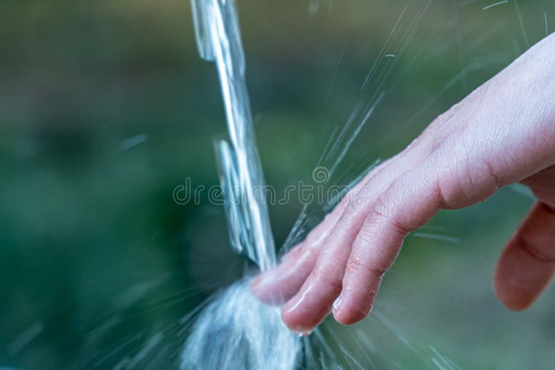 Closeup of Fingers on the Flowing Water from the Faucet Stock Photo ...