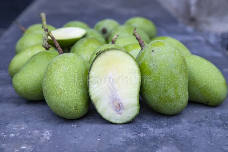 Closeup Focus Fresh Raw Mango with Sliced Mango on the Concrete Floor ...