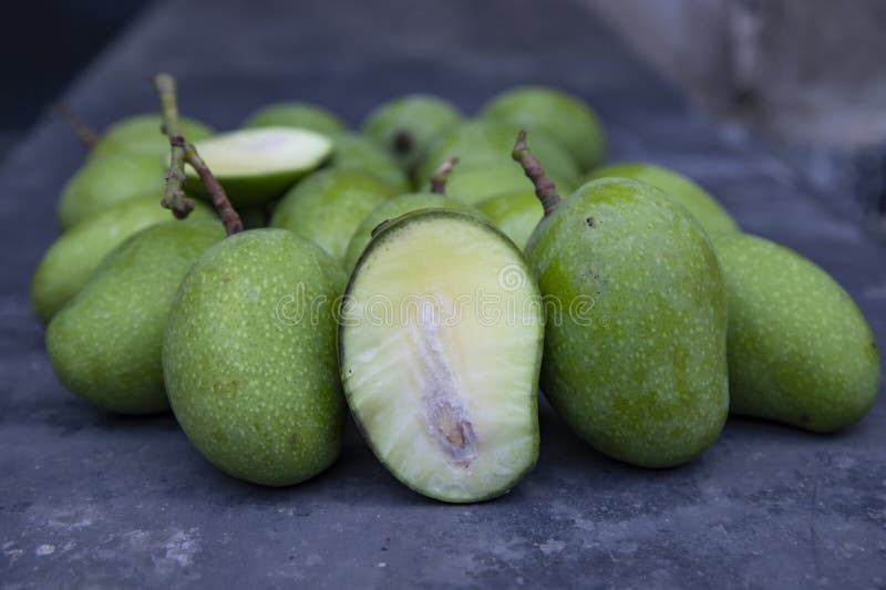 Closeup Focus Fresh Raw Mango with Sliced Mango on the Concrete Floor ...