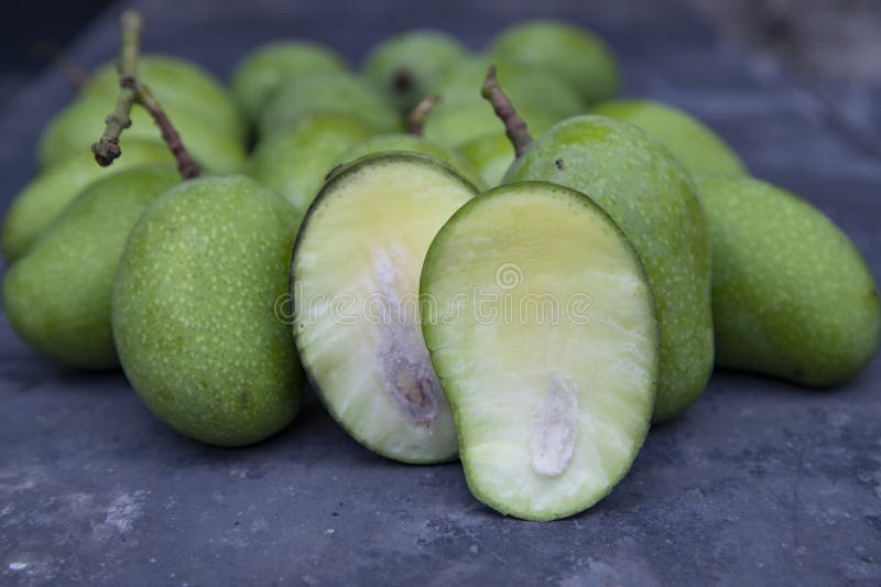 Closeup Focus Fresh Raw Mango with Sliced Mango on the Concrete Floor ...