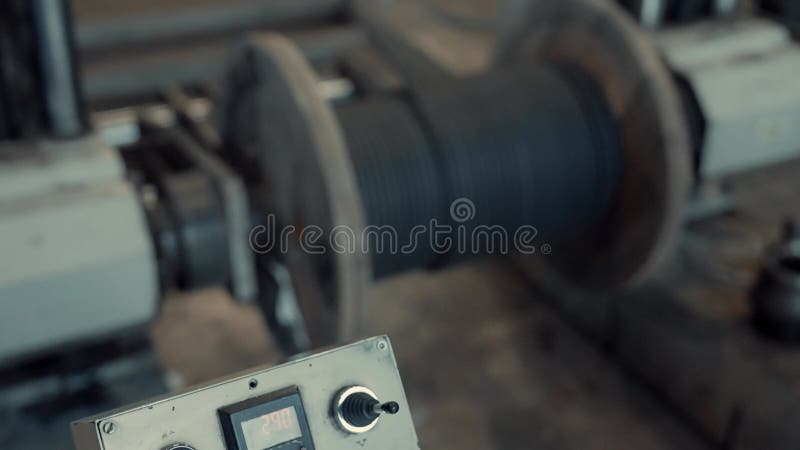 Closeup Footage on the Control Panel of a Machine Rolling a Cable on a ...