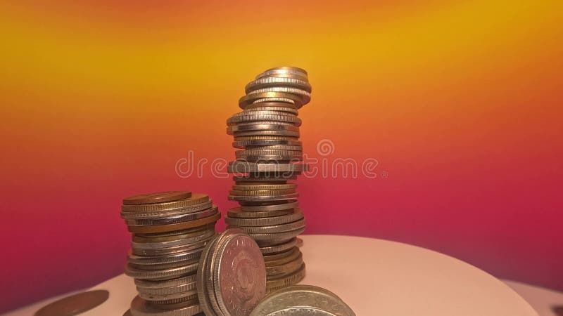 Closeup Footage of Two Stacks of Coins Falling Down on a Rotating Table ...