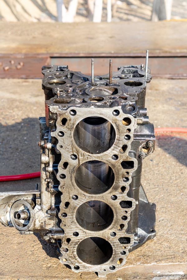Closeup of a Four Cylinder Engine Block for Repair in Workshop Stock ... Closeup of a Four Cylinder Engine Block for Repair in Workshop Stock ...