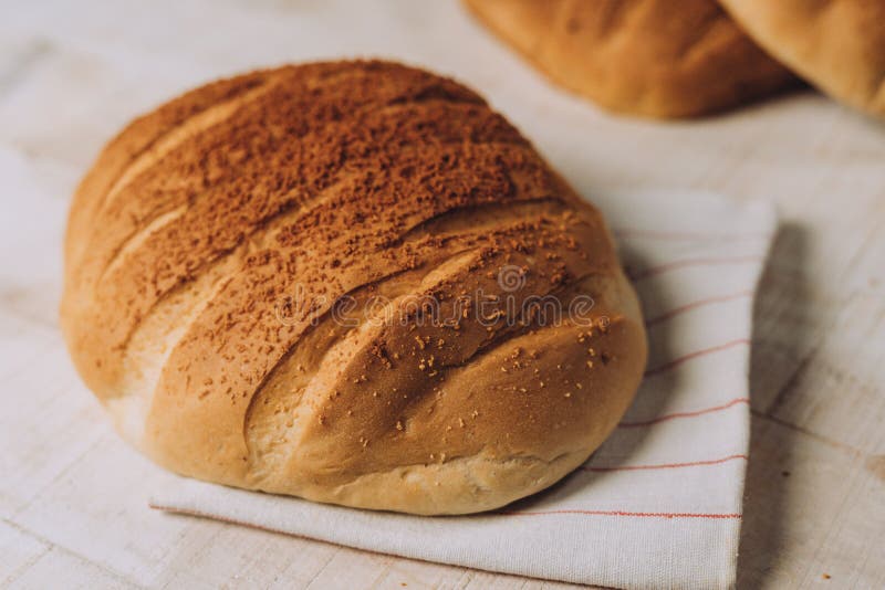 Closeup of Freshly Baked Crusty Bread Put on the White Table Surface ...