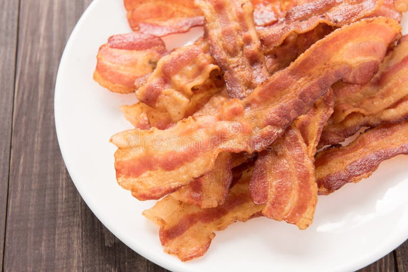 Closeup of Fried Bacon Strips on White Plate Stock Photo - Image of ...