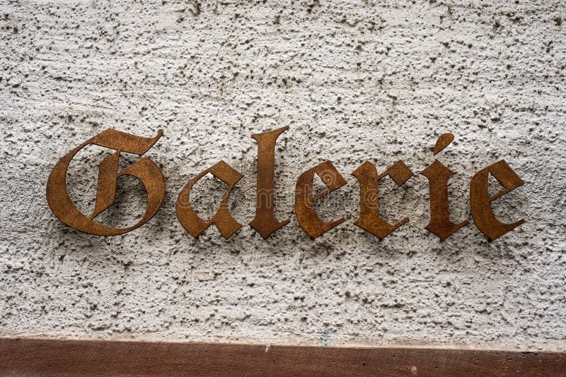 Gallery Sign on Rusty Gothic Letters on the Wall in the Street Stock ...
