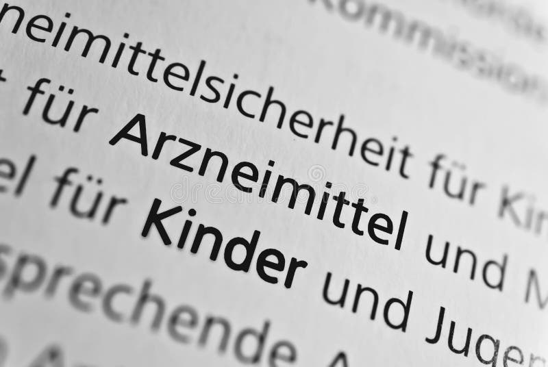 Closeup Of The German Word Kinder Written In Bold Font Surrounded By Blurred Words Stock Image