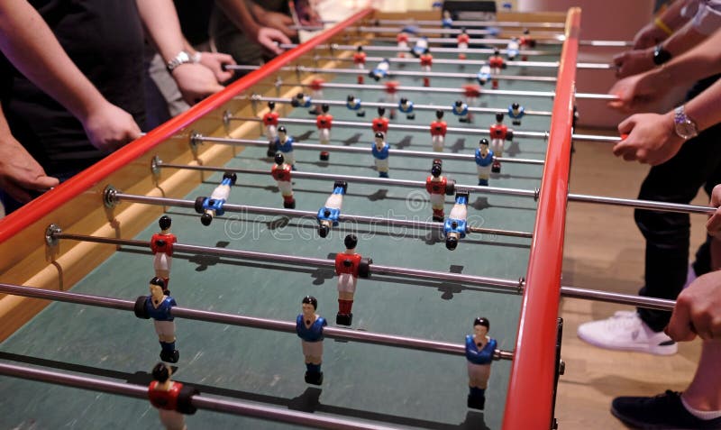 Closeup of a Giant Oversized Football Table and People Hands Playing ...
