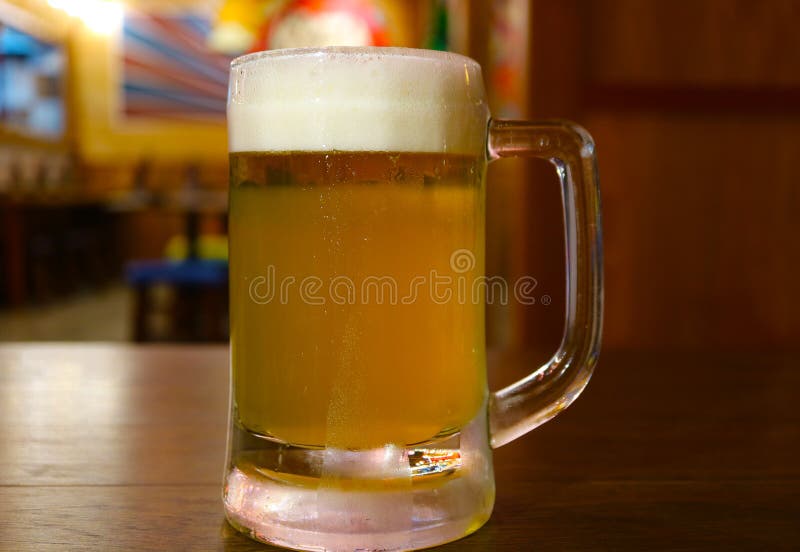 Glass of Chilled Draft Beer Isolated on Wooden Table Stock Photo ...