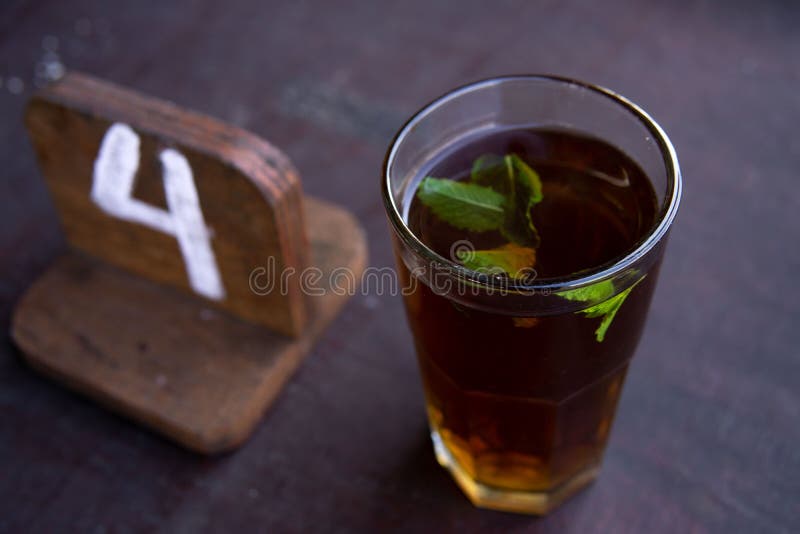 Closeup of a Glass of Hot Mint Tea on a Wooden Table with Initial Table ...