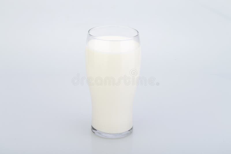 Closeup of a Glass of Milk Under the Lights Isolated on a Grey ...