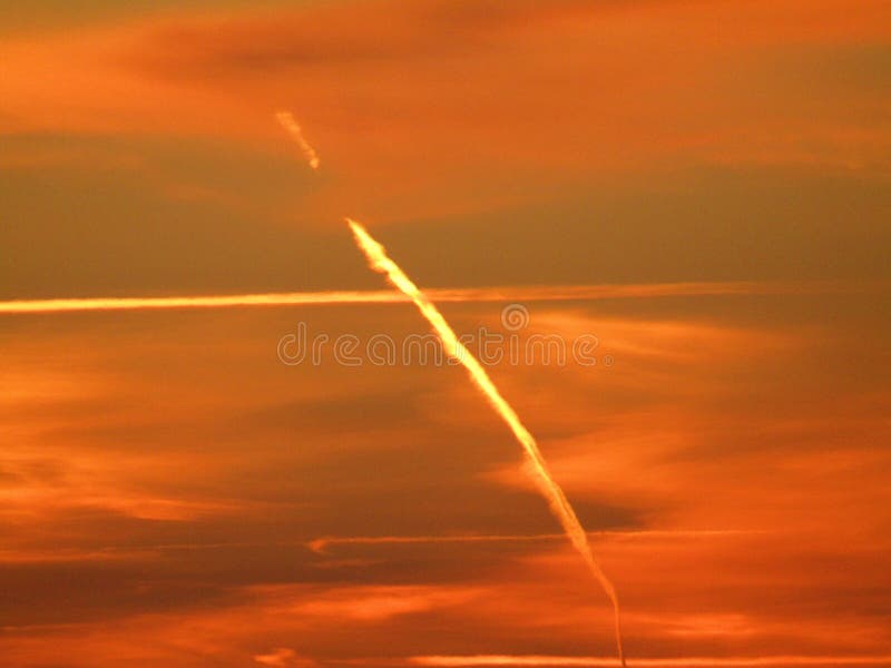 Closeup of the Glowing Light Trails Captured at Sunset in an Orange Sky ...