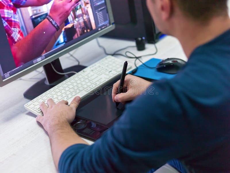 Photo editor at his desk stock photo. Image of computer - 67629872