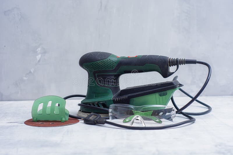 Closeup of Green Electric Orbital Sander on Marble Surface with Sanding ...