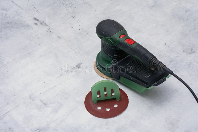Closeup of Green Electric Orbital Sander on Marble Surface with Sanding ...