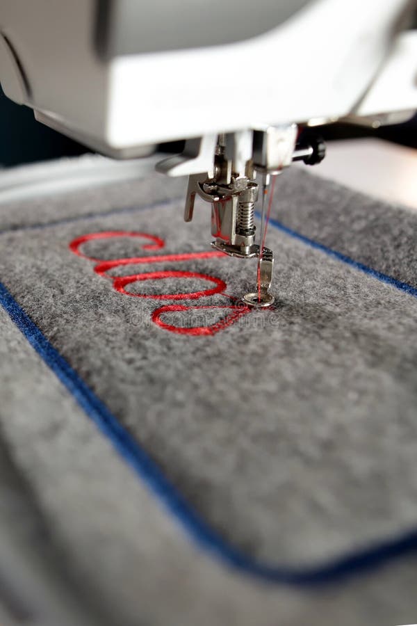 Closeup on Grey Felt with Red Lettering Stitched by a Modern Sewing ...