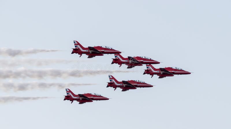 Closeup of Group of Red Planes in Formation with White Arrows and ...
