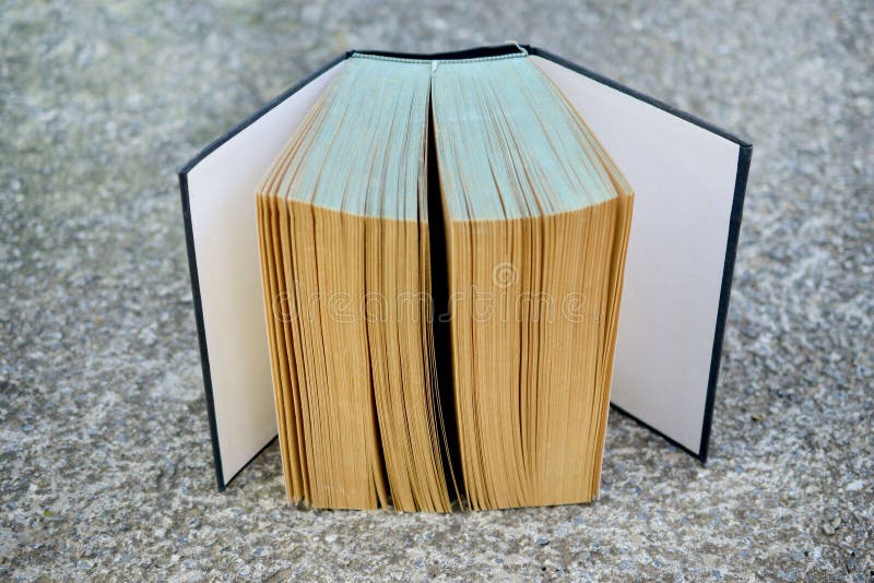 Closeup of a Half Open Book on a Marble Table Stock Photo - Image of ...