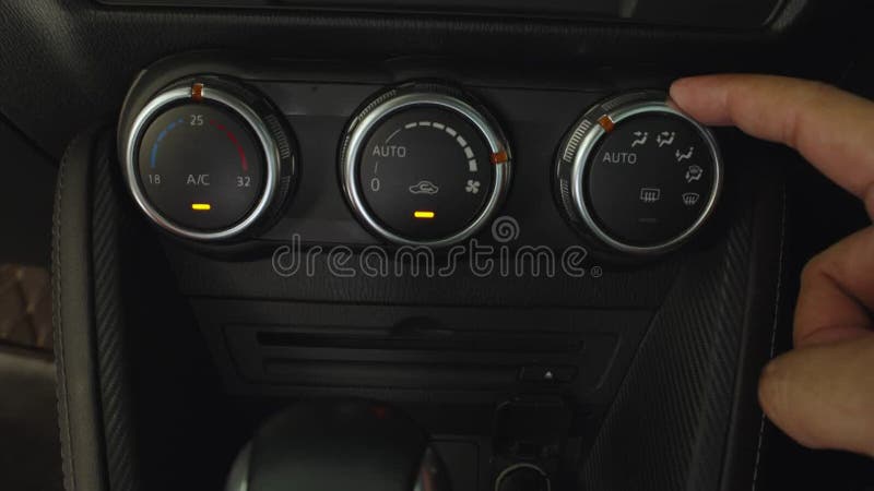Closeup of Hand Adjusting the Air Conditioner Button in the Car while ...