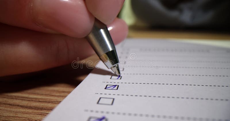 Closeup of Hand Putting Checkmark or Marking with Blue Pen on Checklist ...