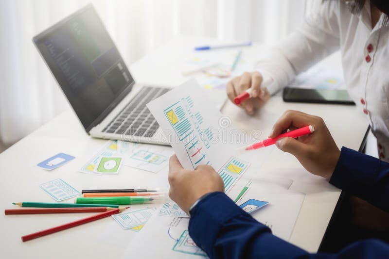 Closeup Hand of Designers Mobile Application with Sketch Drawing ...