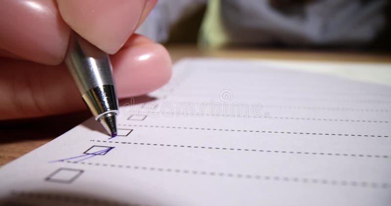 Closeup of Hand Putting Checkmark or Marking with Blue Pen on Checklist ...