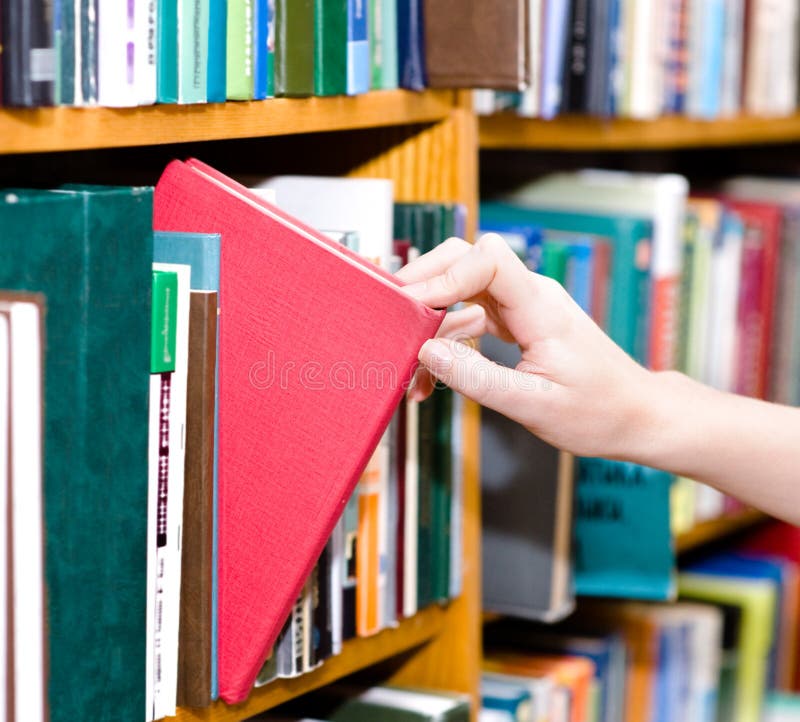Closeup Hand Selecting Book from a Bookshelf Stock Image - Image of ...