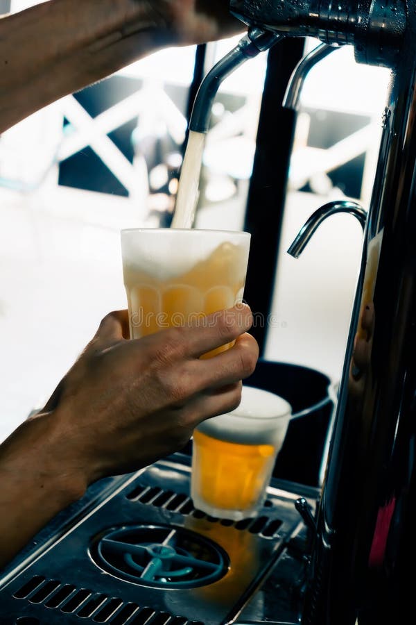 Hand Serving Beer in Glass Using Tap. Bartender Pouring Beer while ...