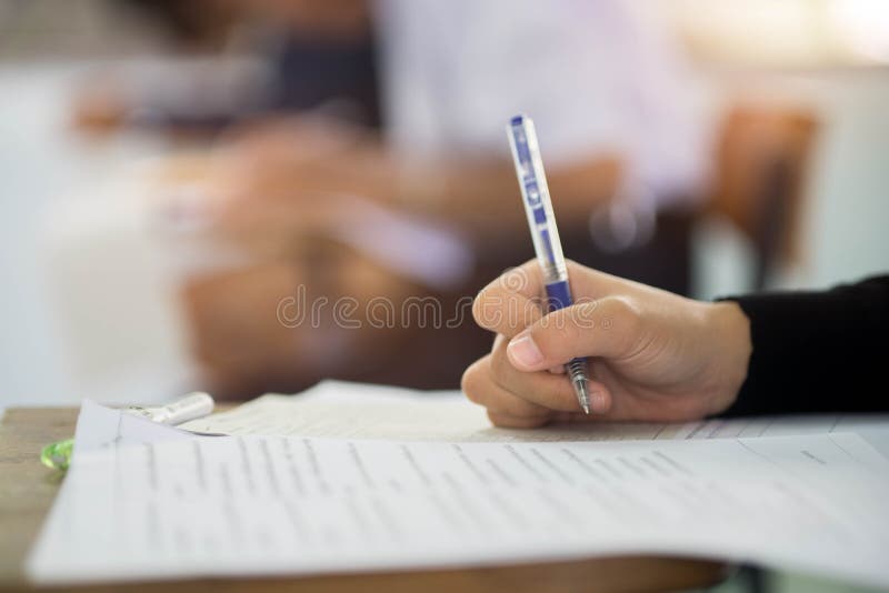 Closeup Hand of Student Reading and Writing Exam with Stress in ...