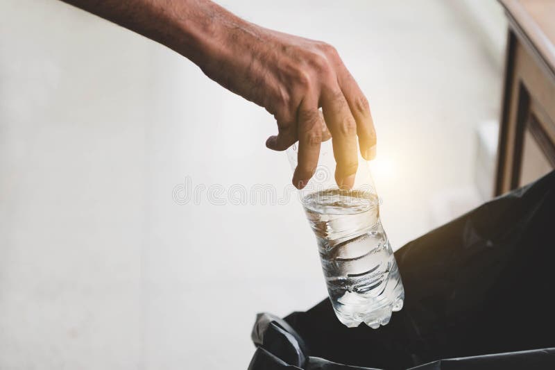 Closeup of Hand Throwing Garbage into Black Bag Bin. Ecology and ...
