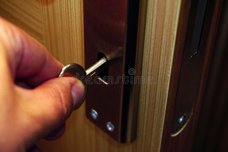 Closeup of a Hand Unlocking the Door with the Key Stock Photo - Image ...