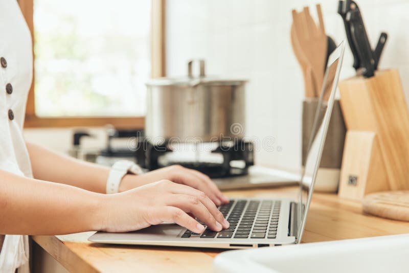 Closeup Hand Using Laptop Computer in Kitchen for Learning Cook Food or ...