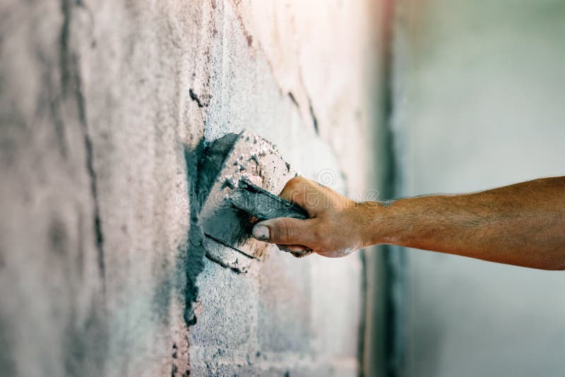 Closeup Hand of Worker Plastering Cement at Wall for Building House ...