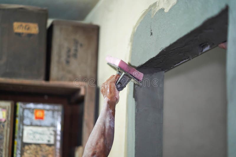 Closeup Hands of Builder Holding Mortar Pan and Sponge Plastering Walls ...