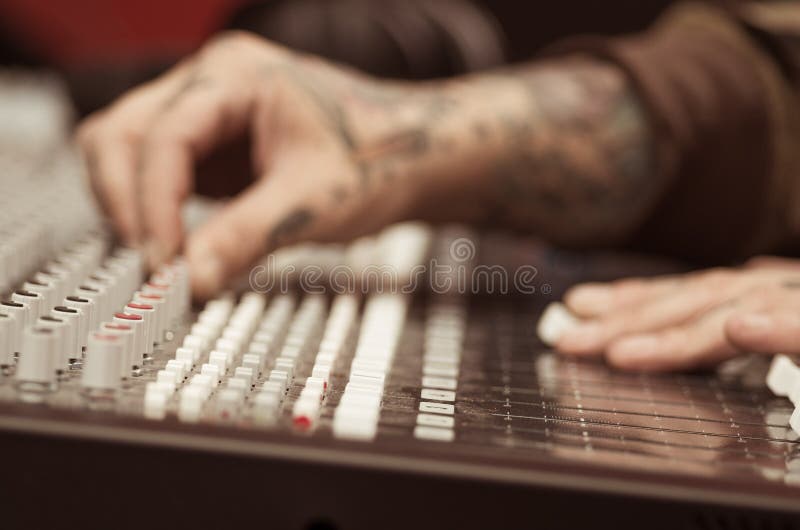 Closeup of Hands Covered with Tattoos Working on Mixer Console ...