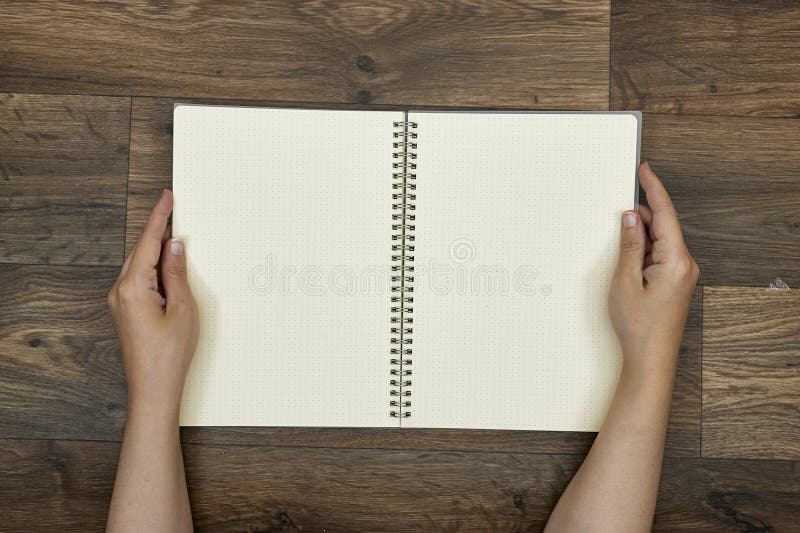 Closeup Hands Holding a Blank Notebook on Wood Table Stock Image ...