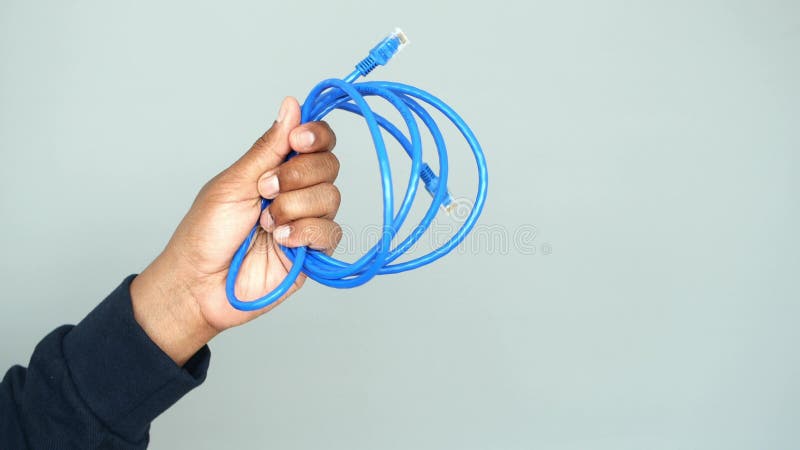 A Closeup of Hands Holding a Coiled Blue Ethernet Cable for a Network ...