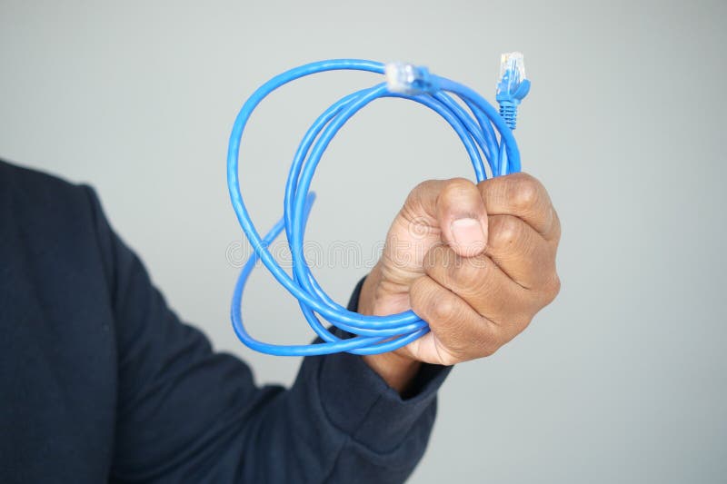 A Closeup of Hands Holding a Coiled Blue Ethernet Cable for a Network ...